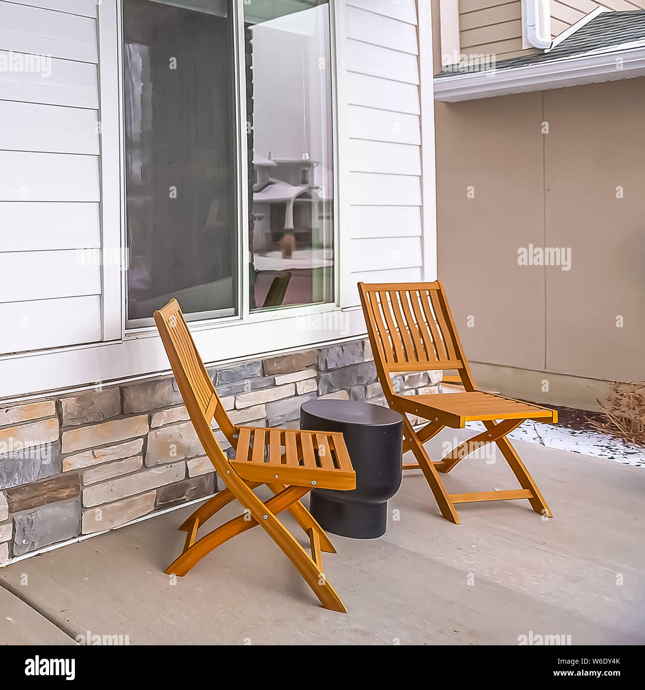 Square frame Home facade with glass paned front door and furniture on ...