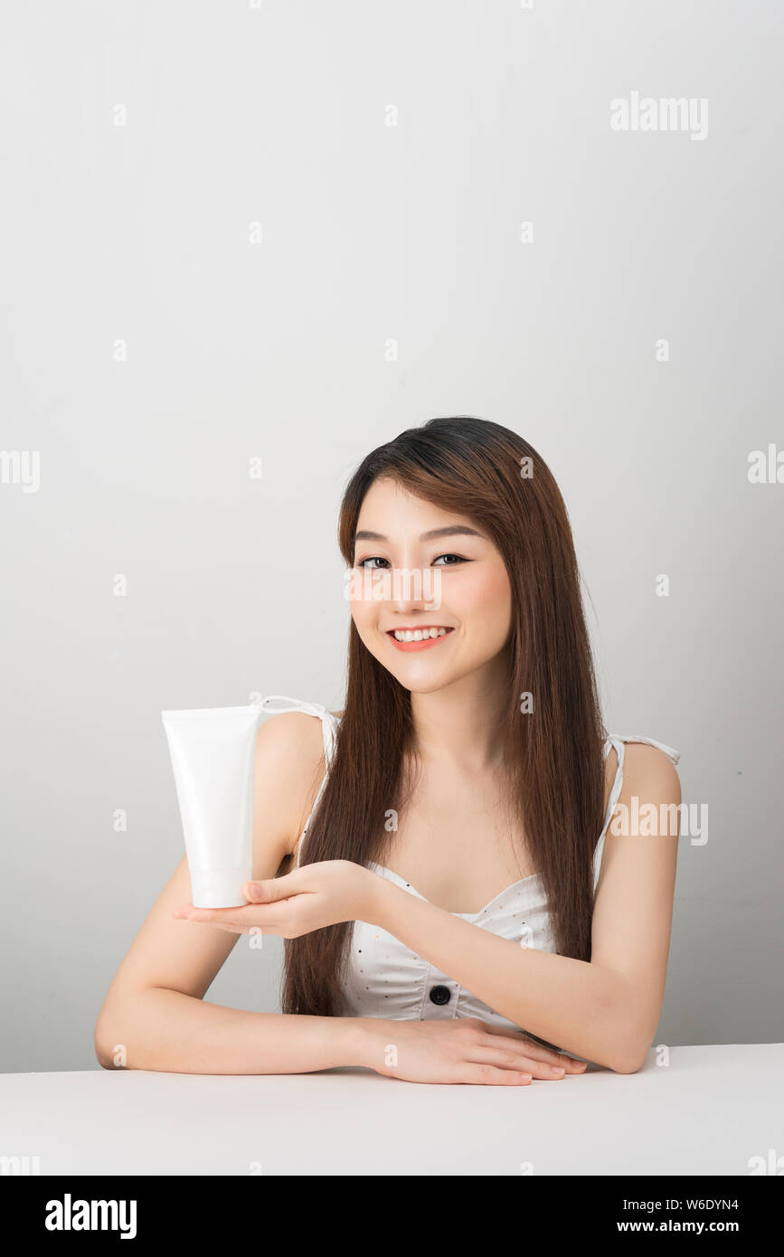Asian woman model present showing cosmetic products isolated on white ...