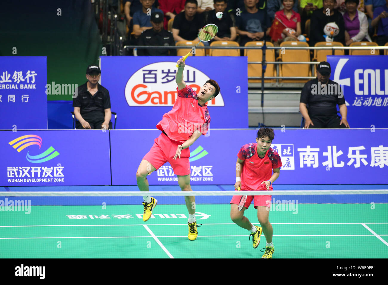 Wang Yilyu, left, of China returns a shot as he and Huang Dongping ...