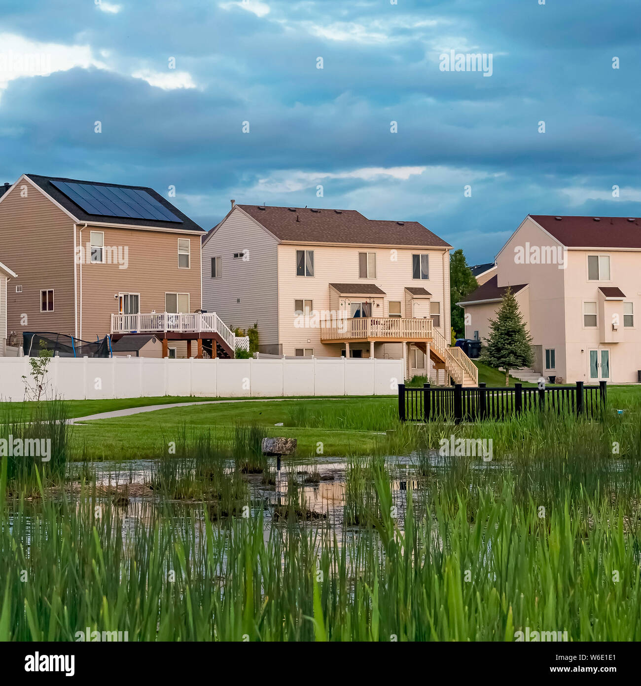 Square Grassy pond with bridge in the middle of a field in front of ...