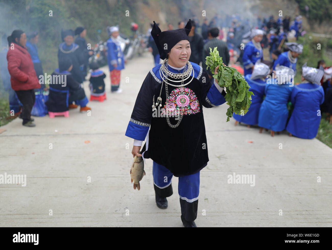 A Chinese woman of Miao ethnic group dressed in traditional costume is ...