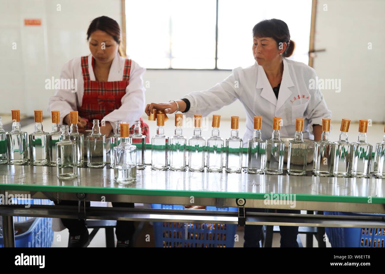 Chinese workers produce bottles of Bijie Daqu, a sub-brand Chinese ...
