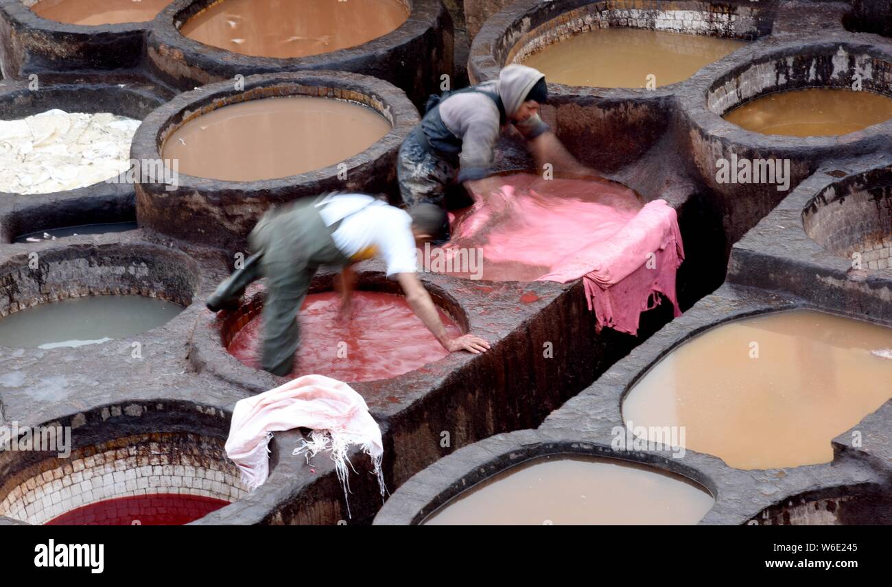 --FILE--Workers soak leather in the pools of honeycomb vats containing ...