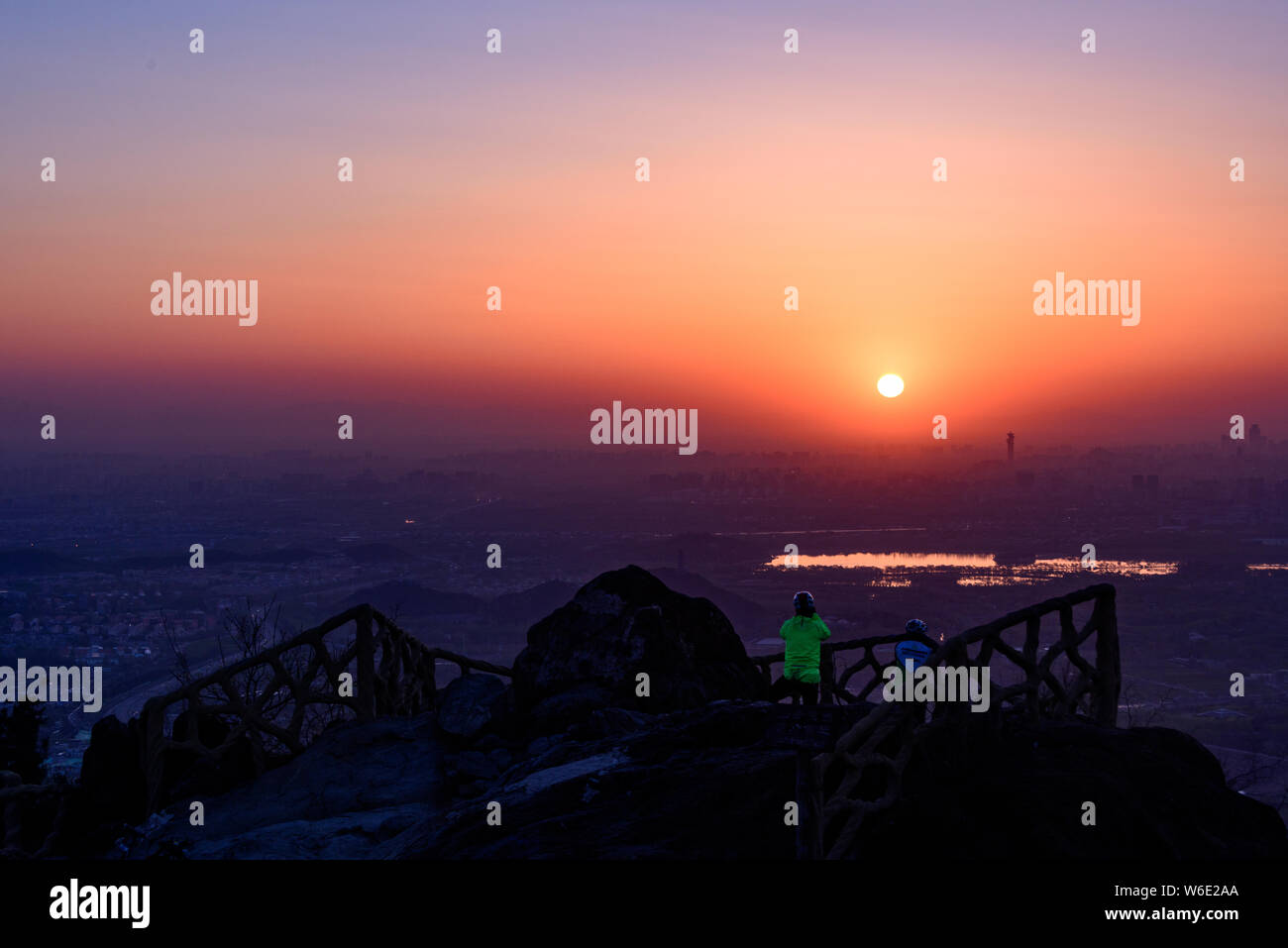 The sun rises over skyline viewed from the top of the Beijing Xishan ...