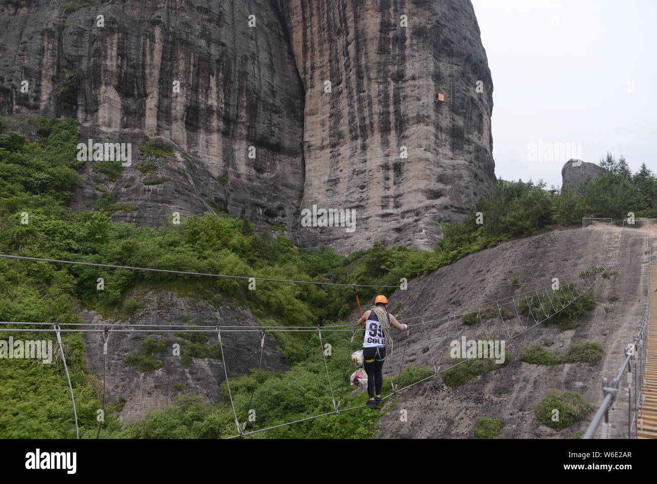 The owner of the 100-meter-high convenience store carries snacks to his ...