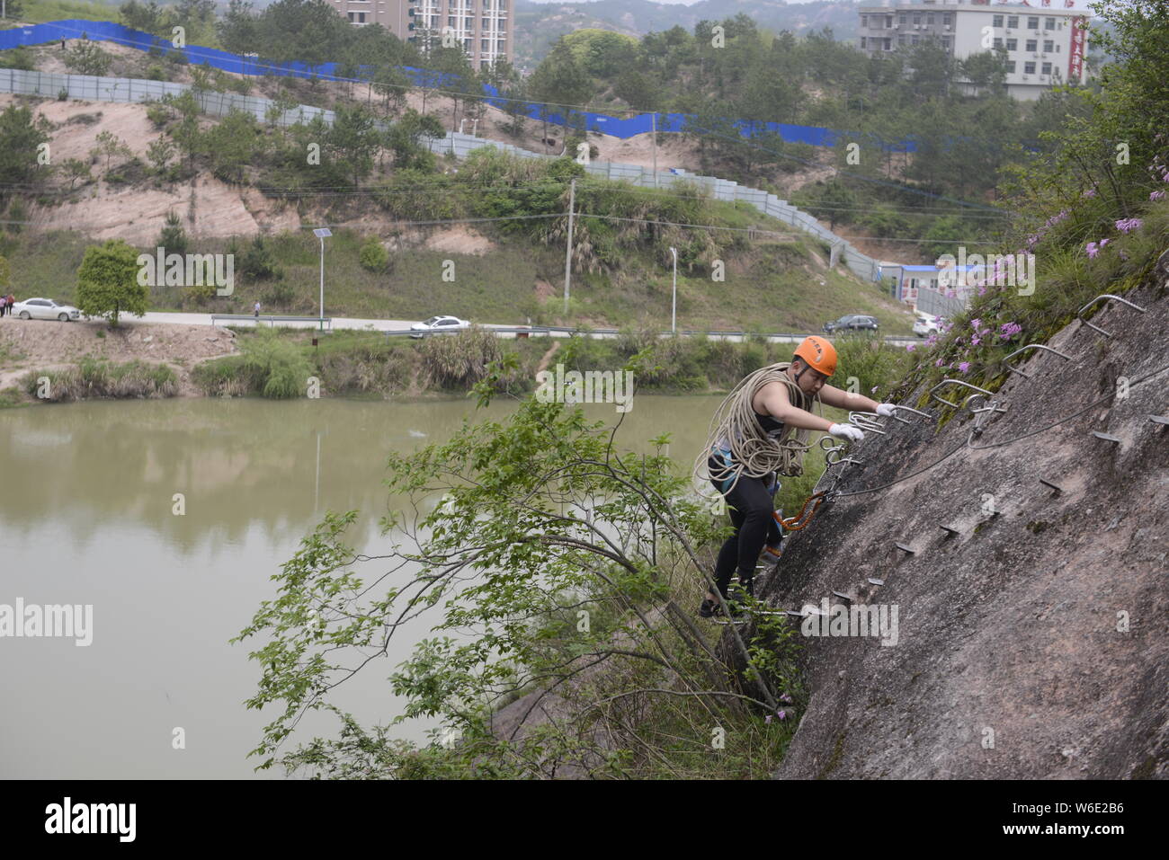 The owner of the 100-meter-high convenience store carries snacks to his ...