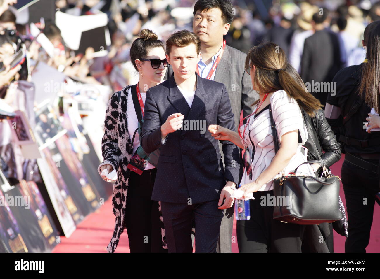 English actor Tom Holland signs autographs for fans as he arrives on ...