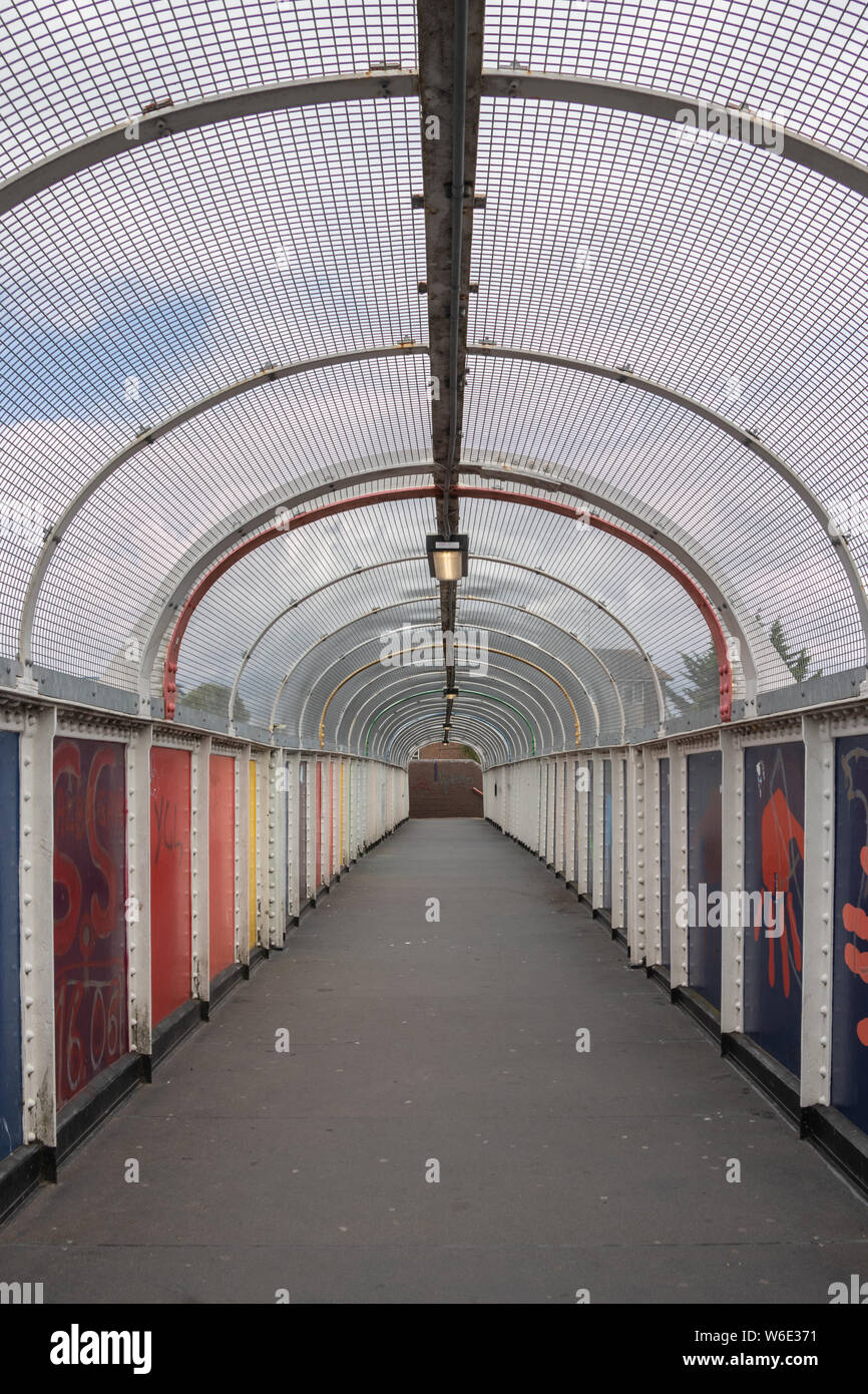 An iron footbridge over a railway, a typical urban footpath Stock Photo ...