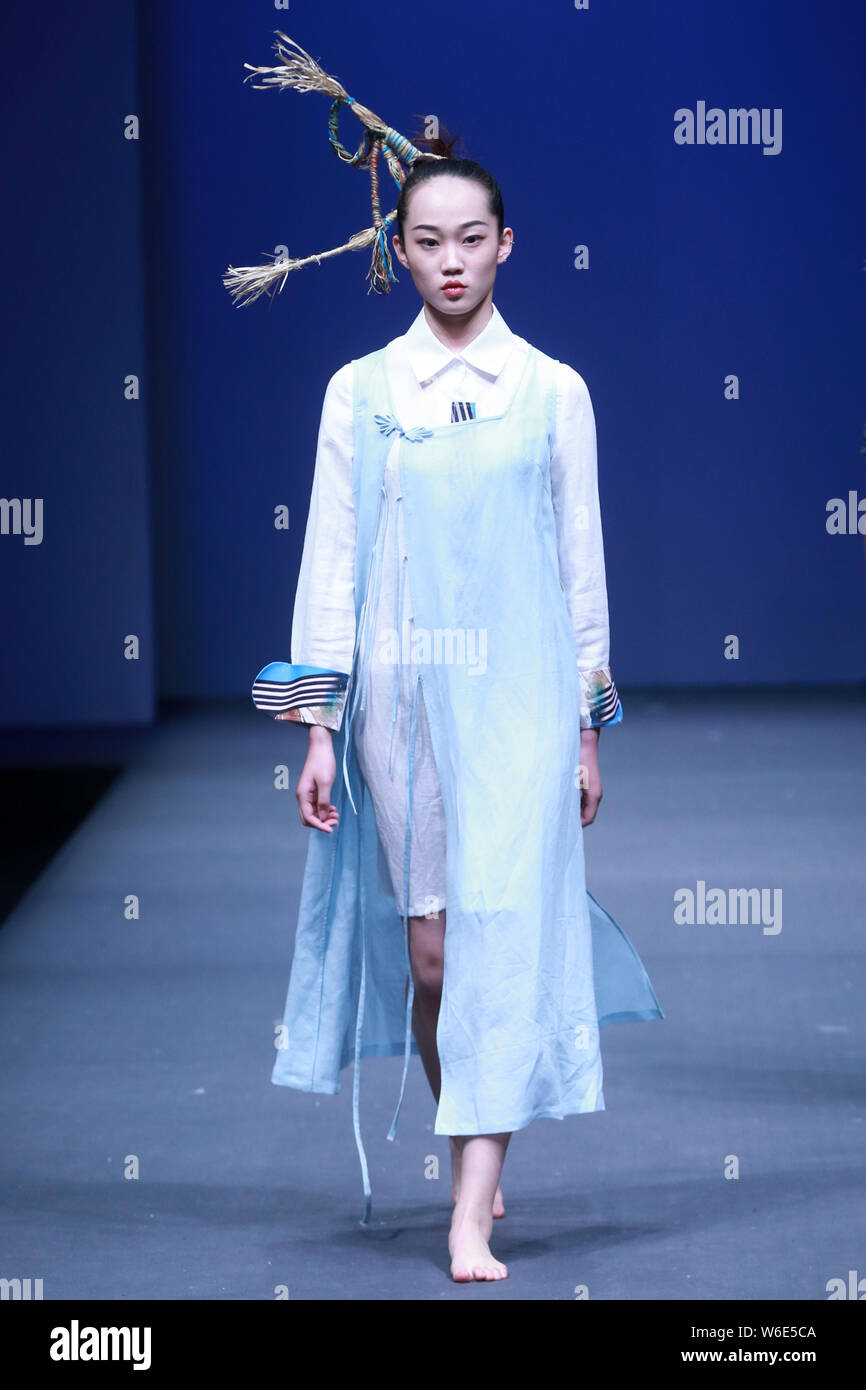 A model displays a new creation at the fashion show of Chan Zhe by Zhao ...