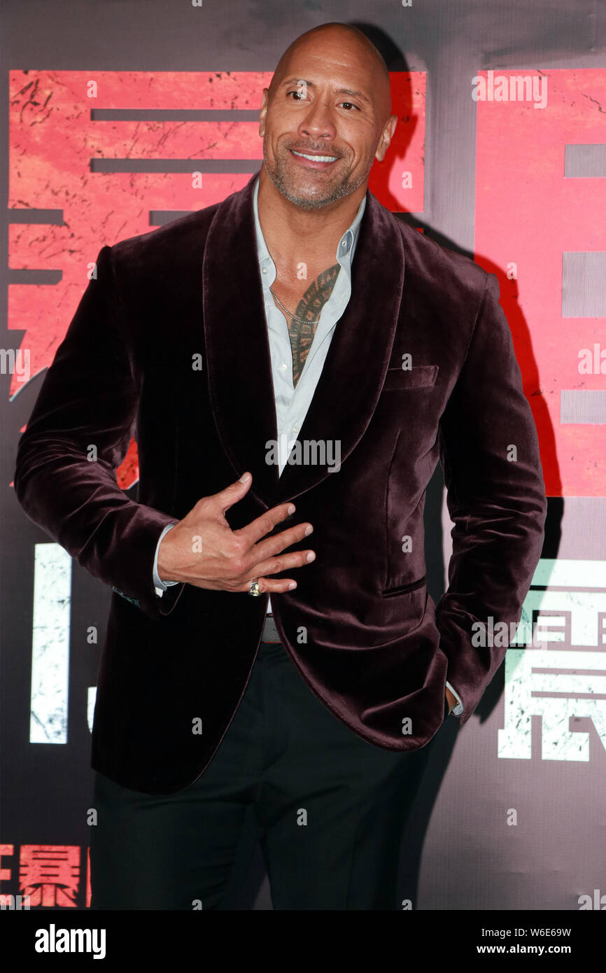 American actor Dwayne Johnson poses as he arrives on the red carpet to ...