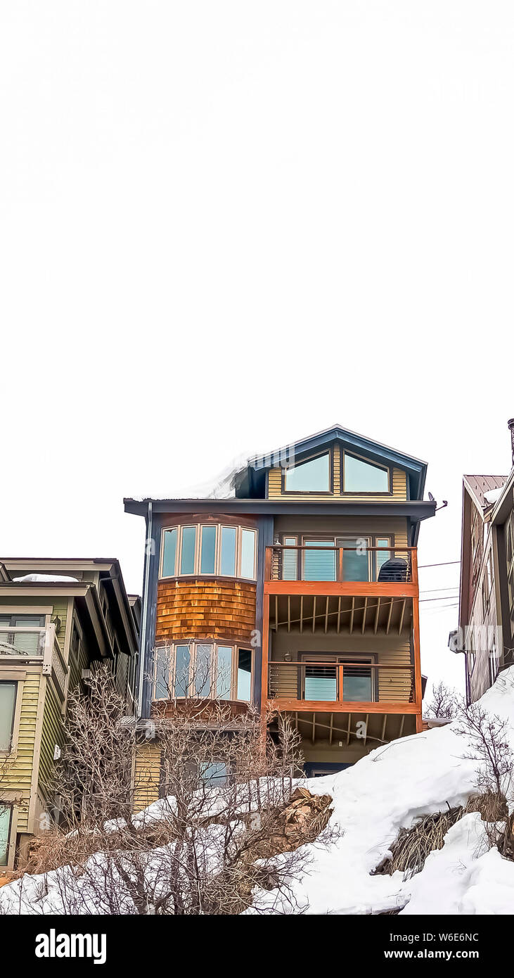 Vertical Exterior view of houses with balconies and built on a hill ...