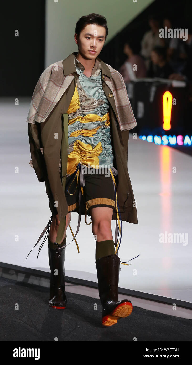 A model displays a creation of MENSWEAR by a graduate during a fashion ...
