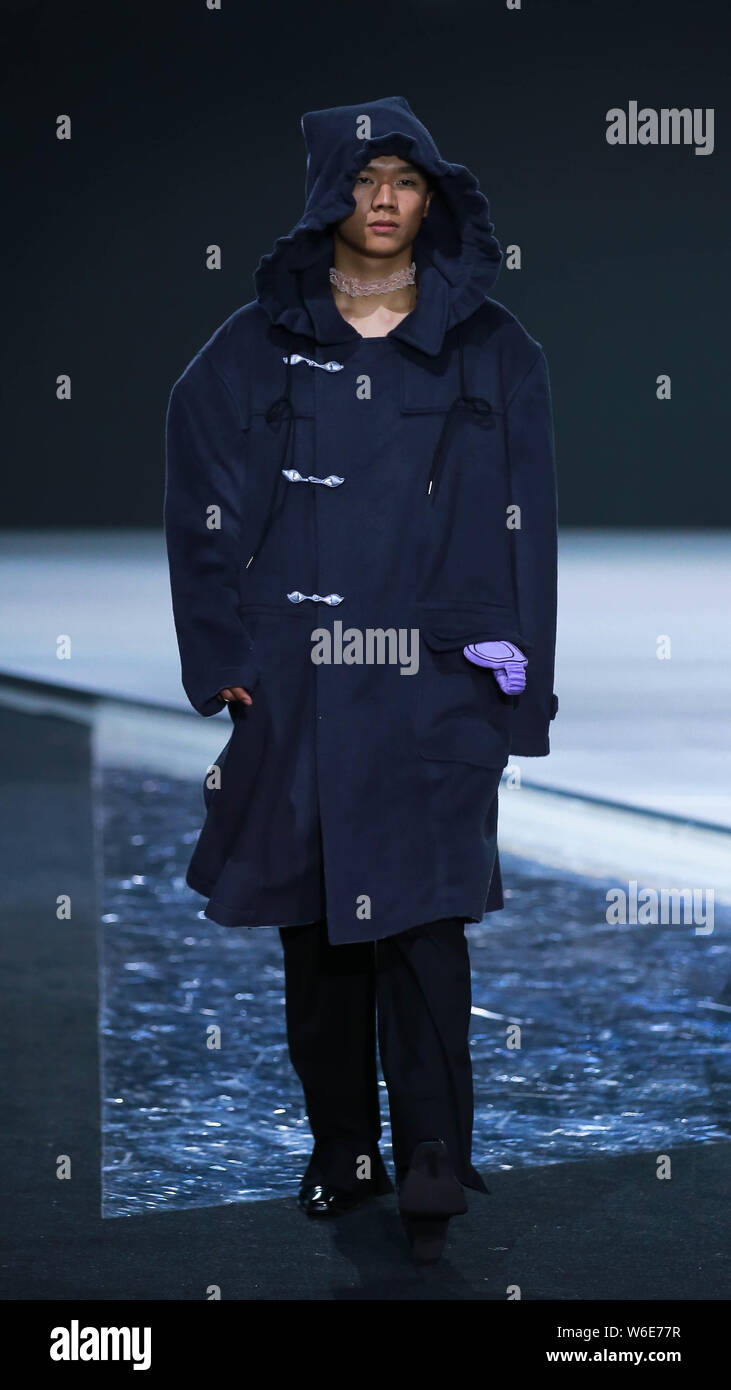 A model displays a creation of MENSWEAR by a graduate during a fashion ...