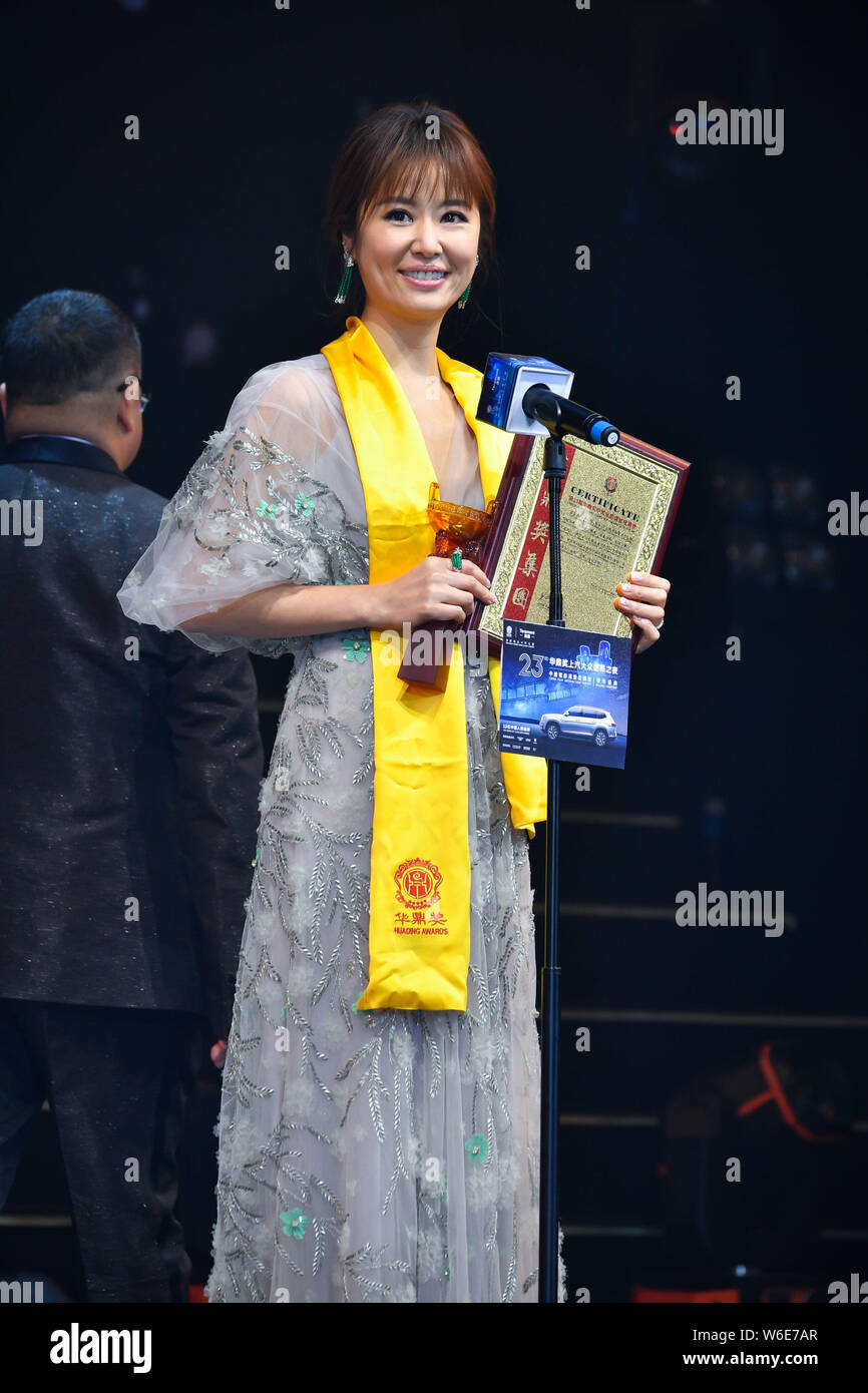 Taiwanese actress Ruby Lin poses with her trophy after winning the Best ...