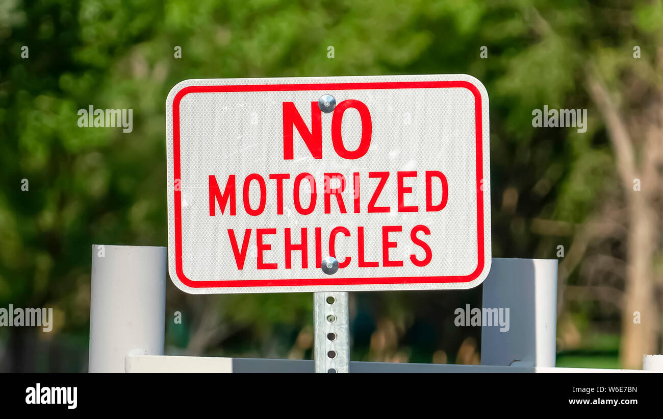 Panorama Close up view of a No Motorized Vehicle sign against a road ...