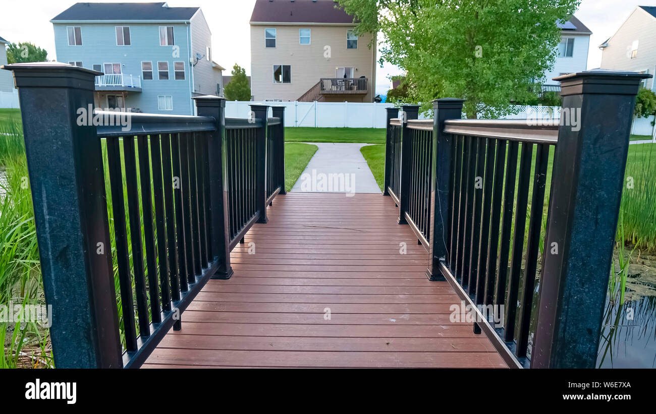 Panorama frame Close up of bridge with brown wood deck and black ...