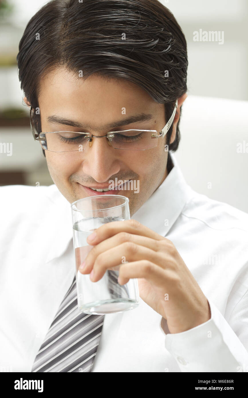Businessman drinking water Stock Photo - Alamy
