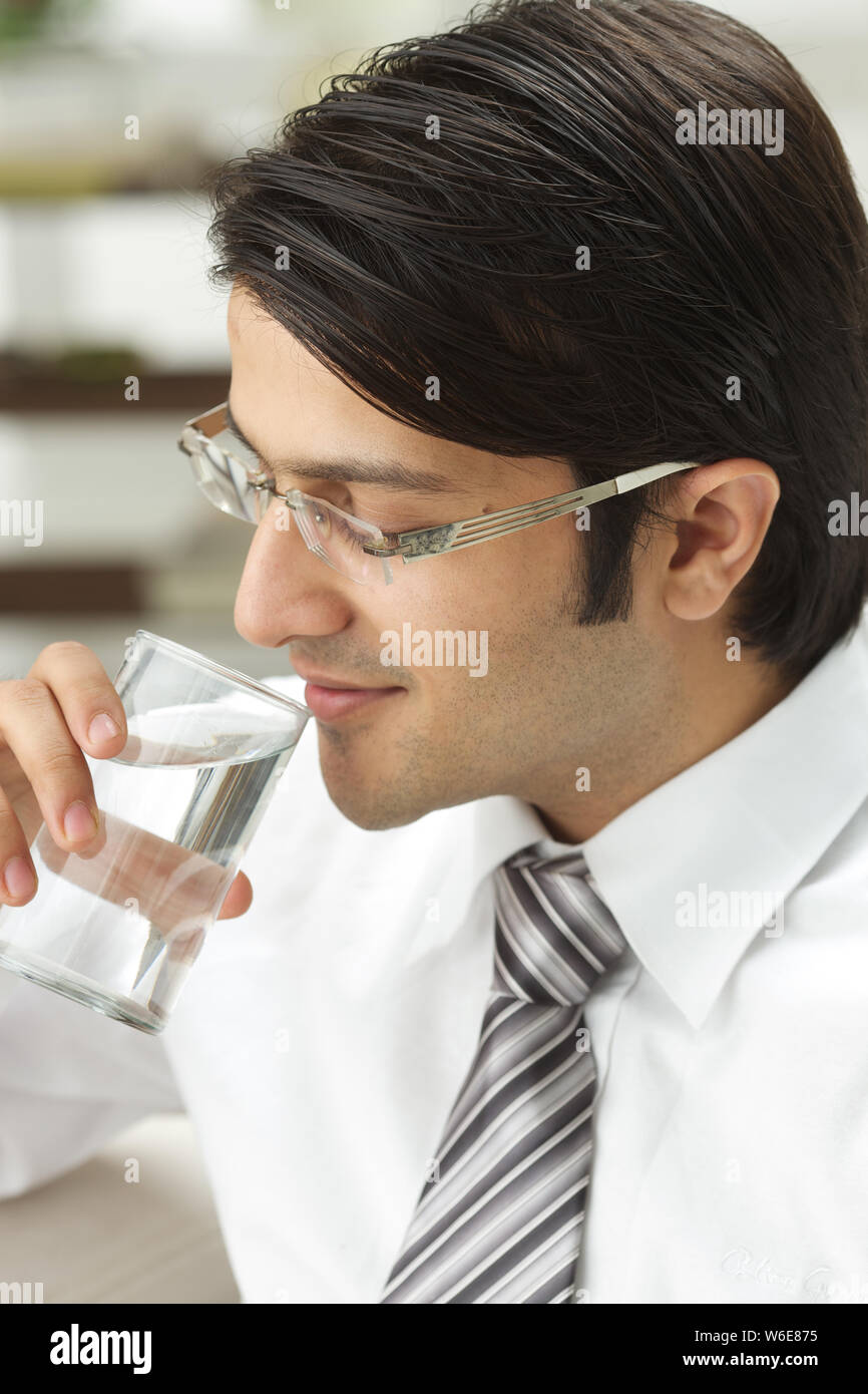 Businessman drinking water Stock Photo - Alamy