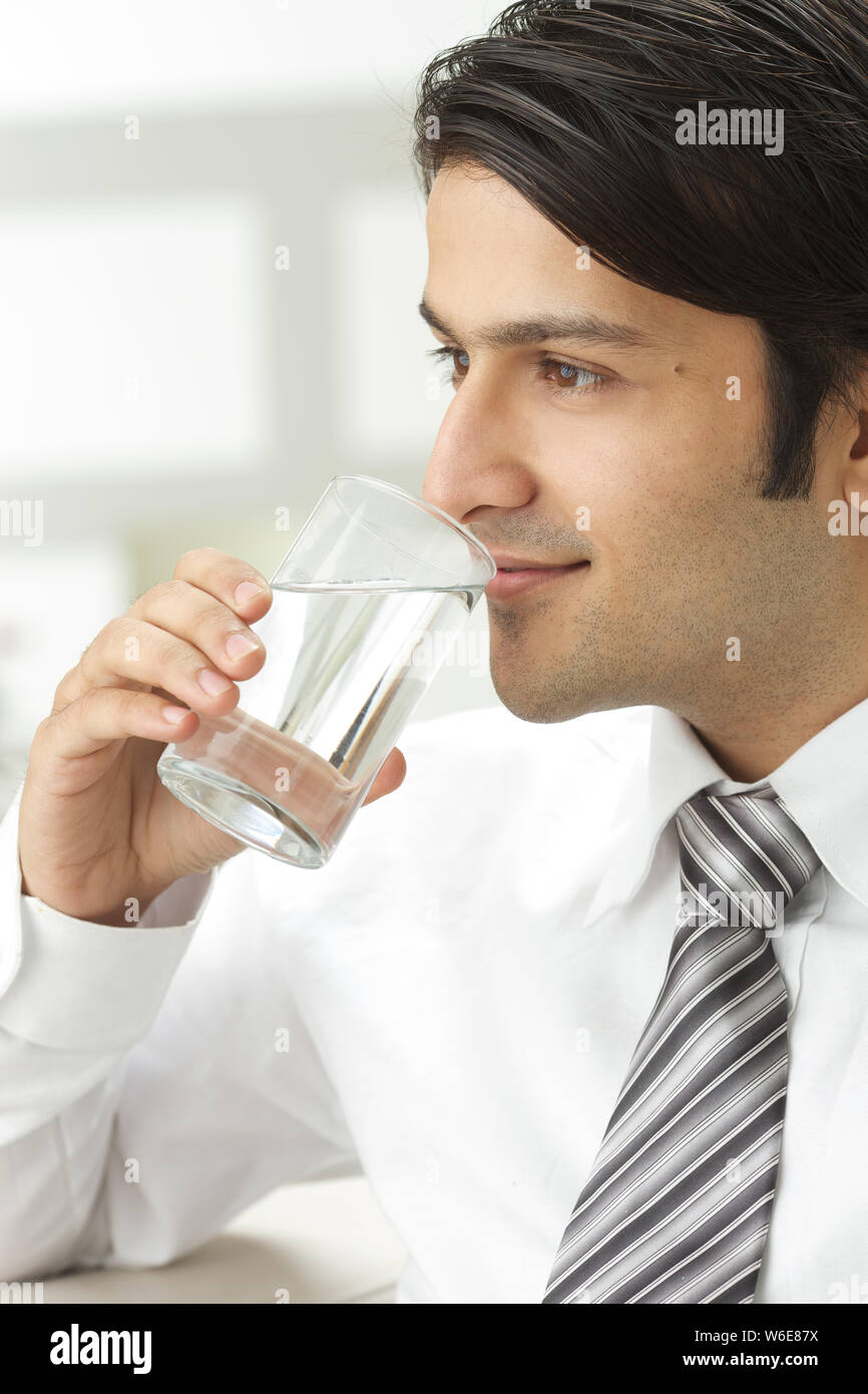 Businessman drinking water Stock Photo - Alamy