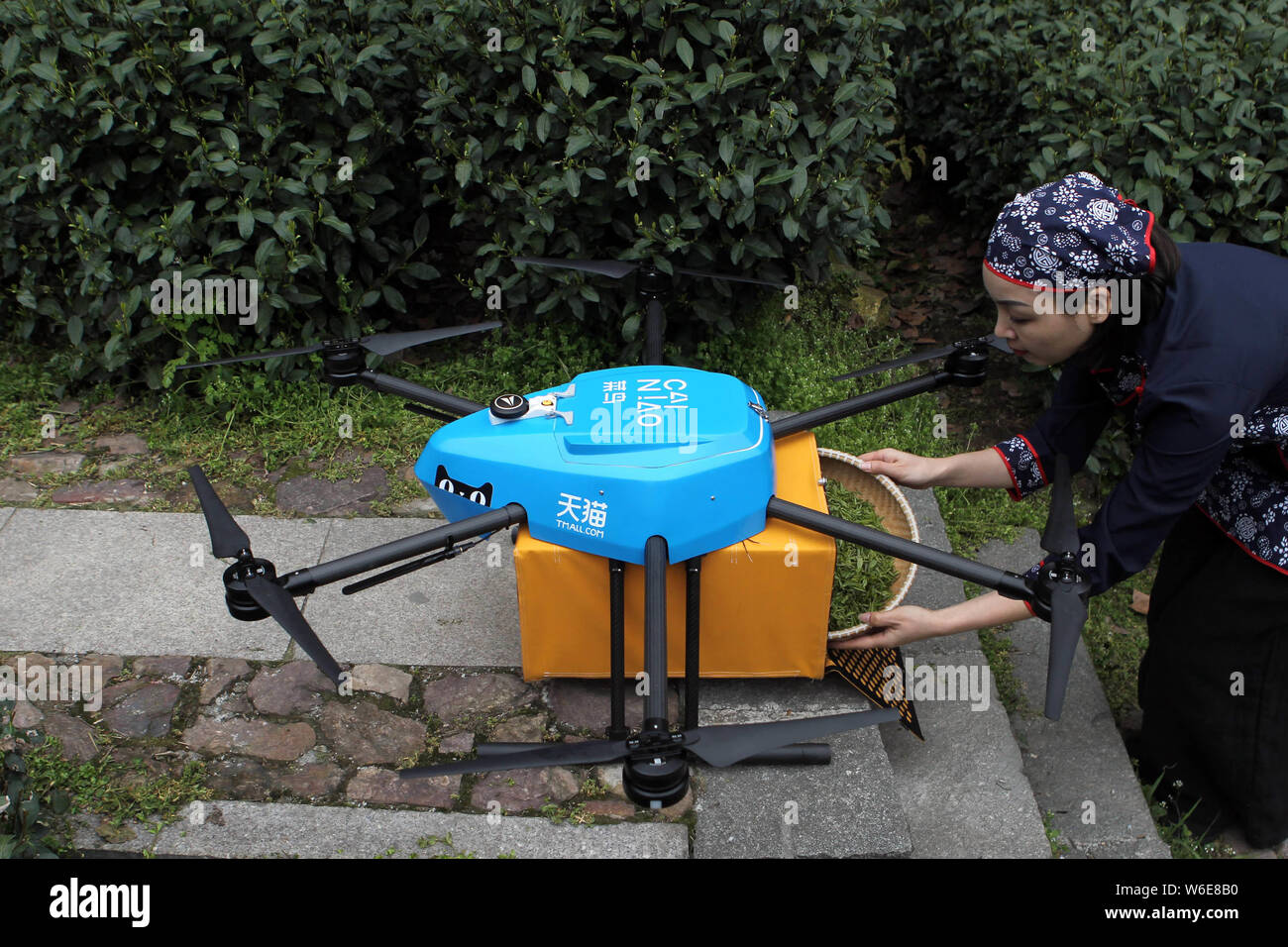 A Chinese girl uses a drone or UAV (unmanned aerial vehicle) of Alibaba ...