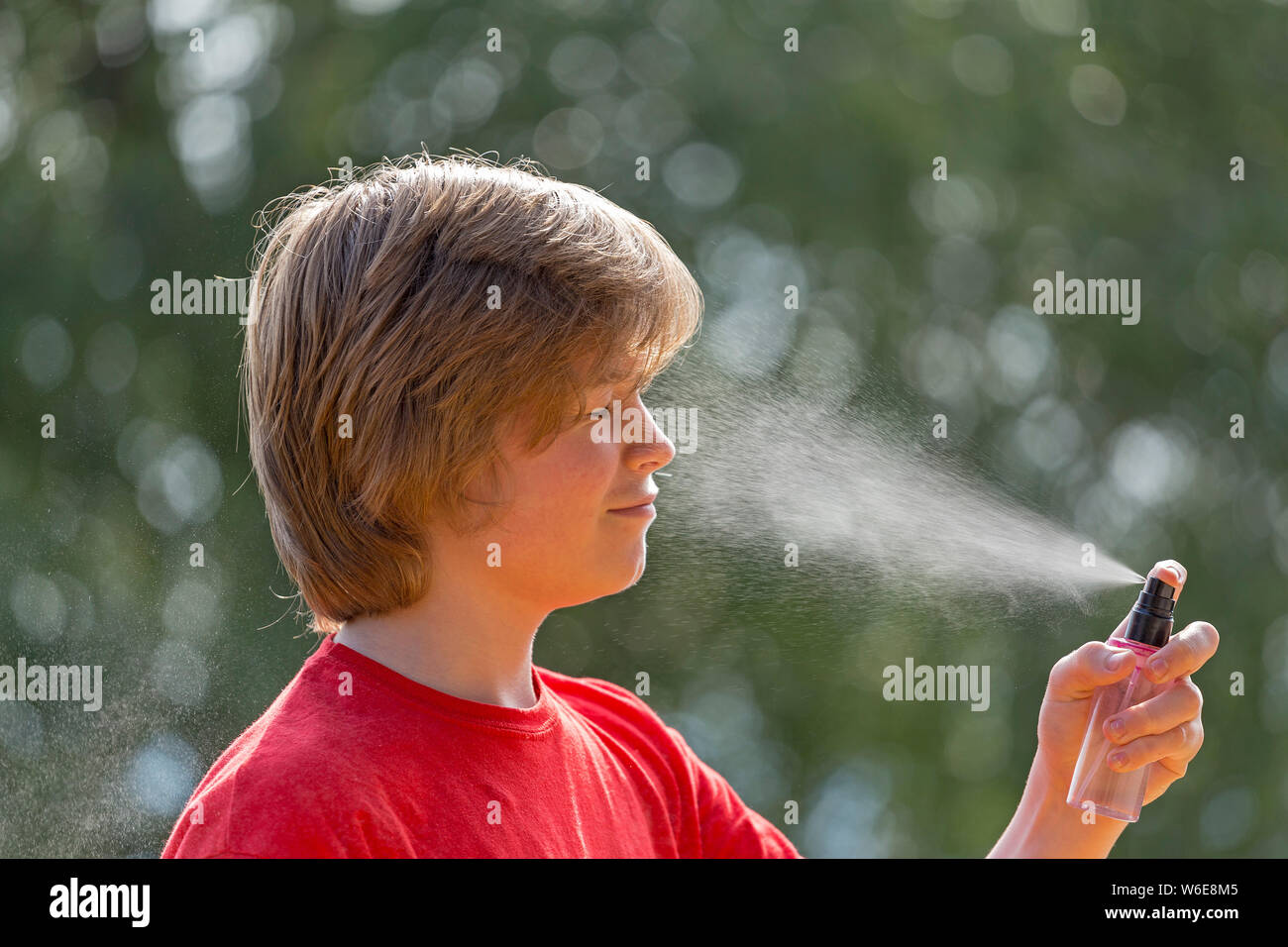boy spraying water into his face, Freiberg, Bayerischer Wald, Bavaria ...