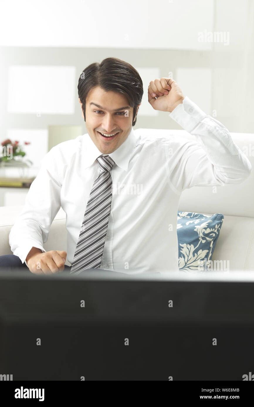 Businessman watching tv Stock Photo - Alamy