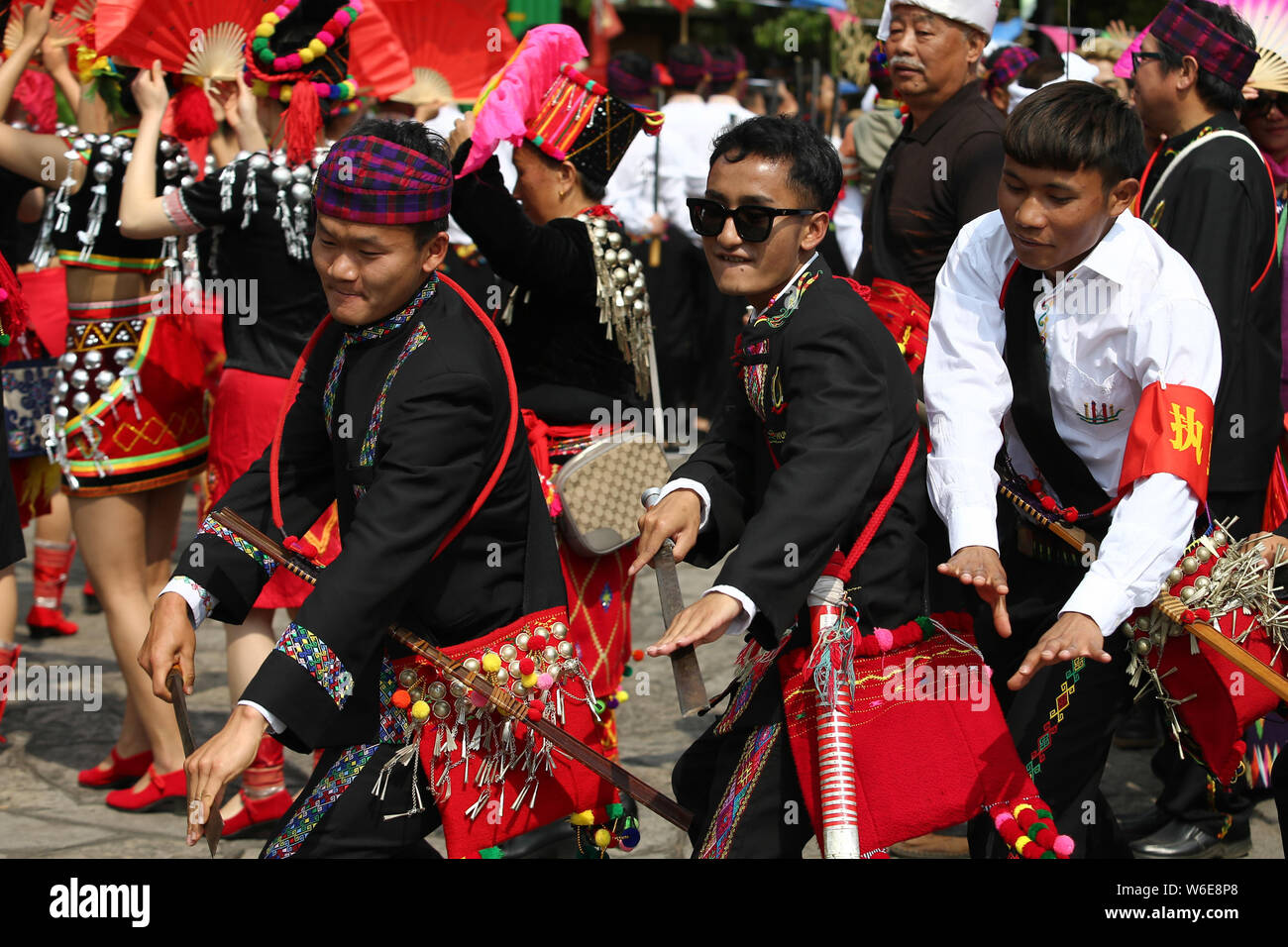 Chinese people of Jingpo ethnic group wearing traditional costumes and ...