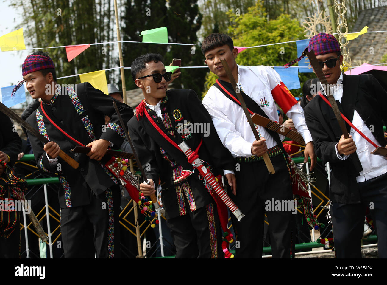 Chinese people of Jingpo ethnic group wearing traditional costumes and ...