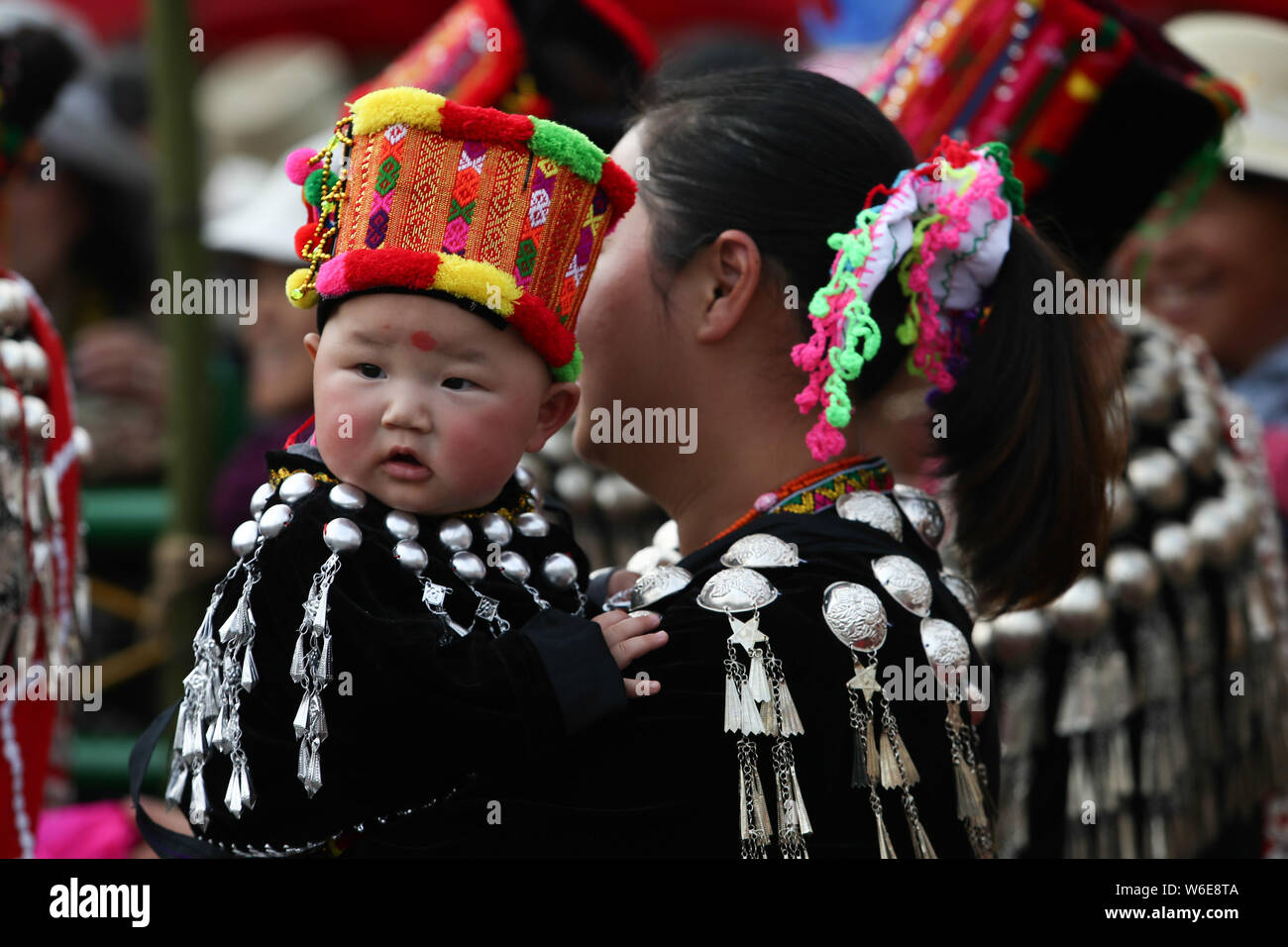 Chinese people of Jingpo ethnic group wearing traditional costumes and ...
