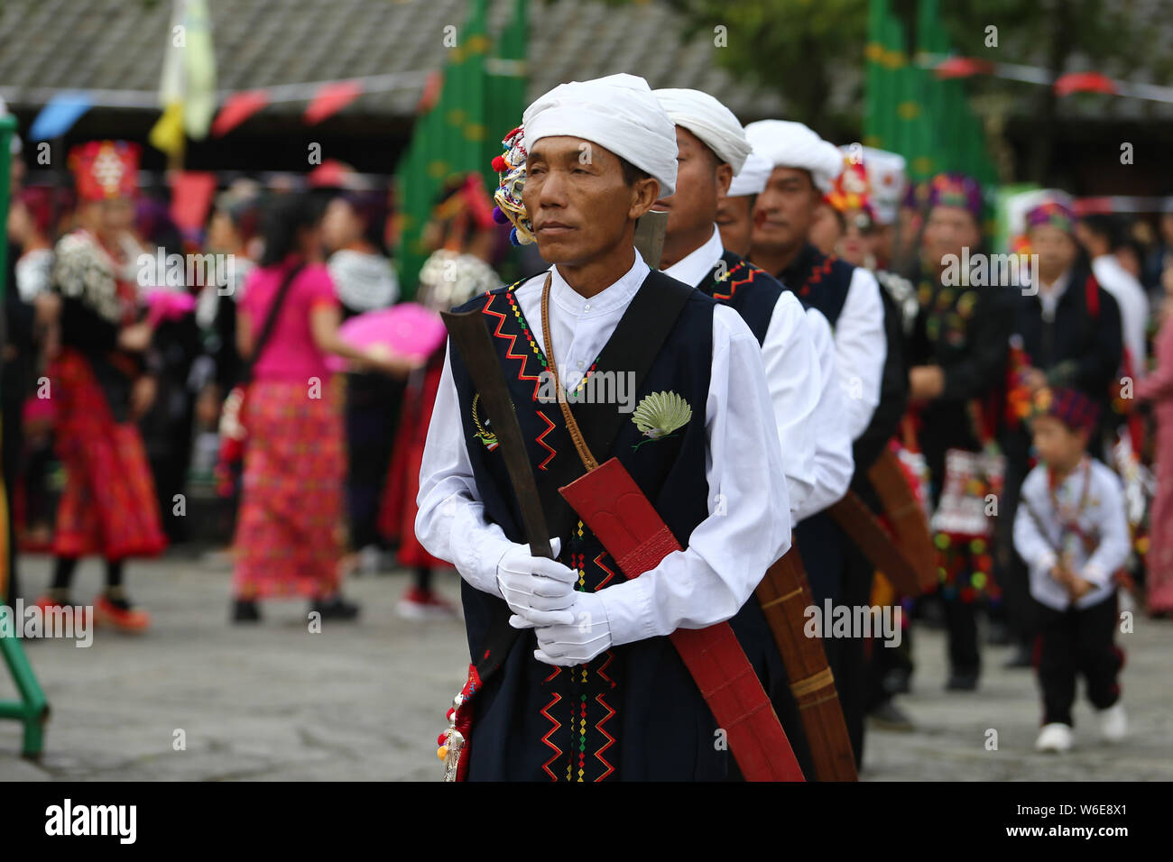 Chinese people of Jingpo ethnic group wearing traditional costumes and ...