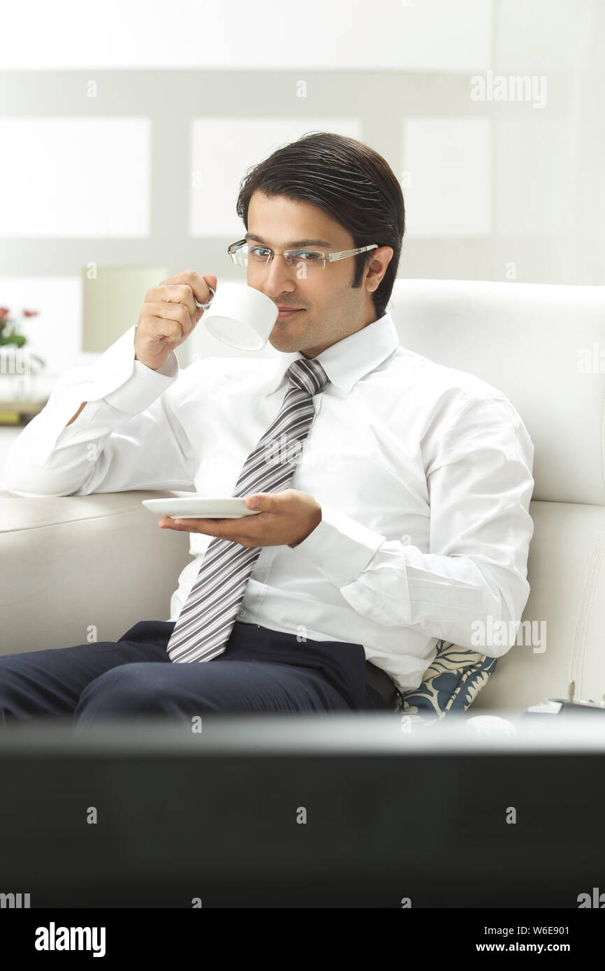 Man watching tv drinking coffee hi-res stock photography and images - Alamy