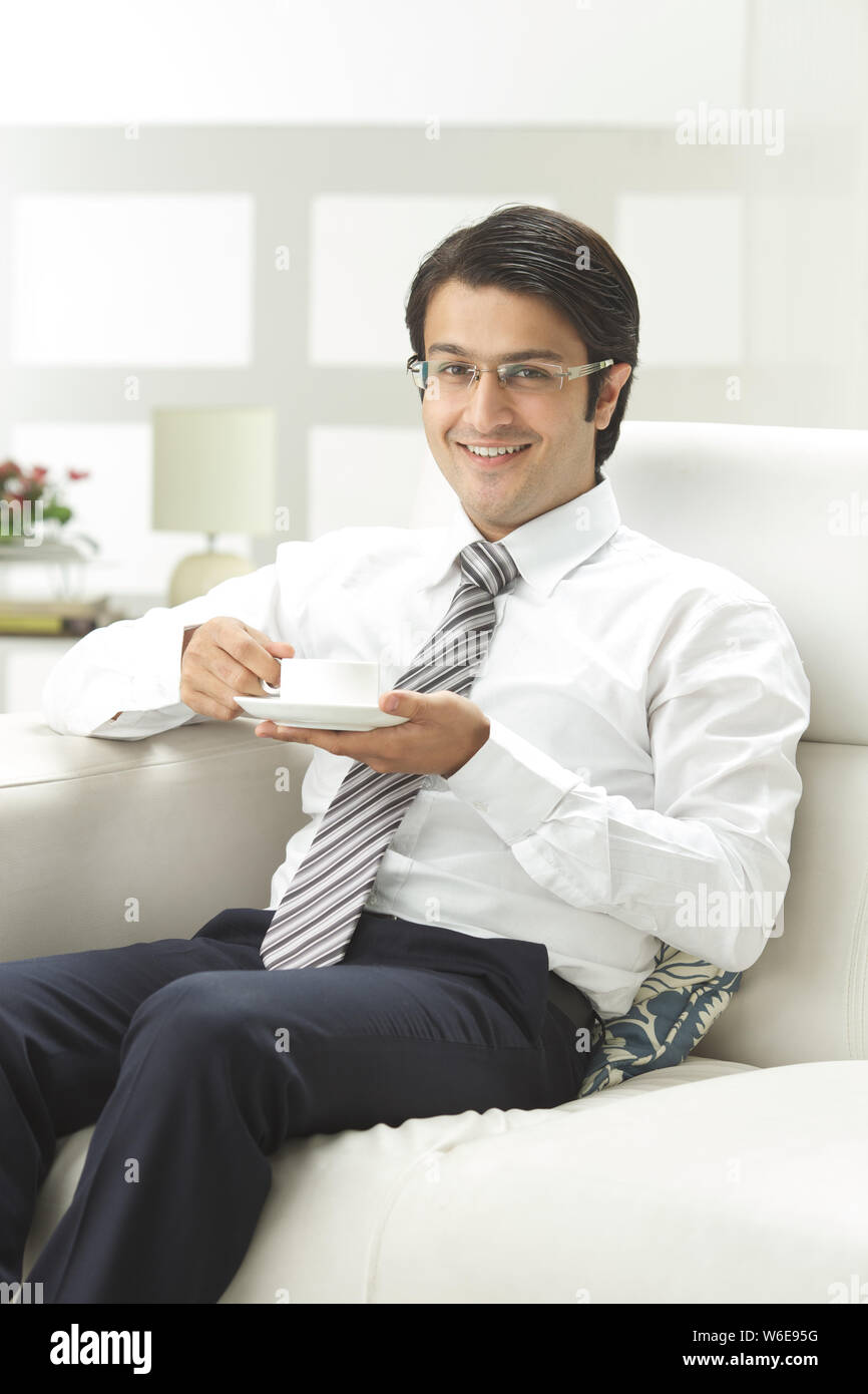 Businessman drinking coffee smiling camera hi-res stock photography and ...