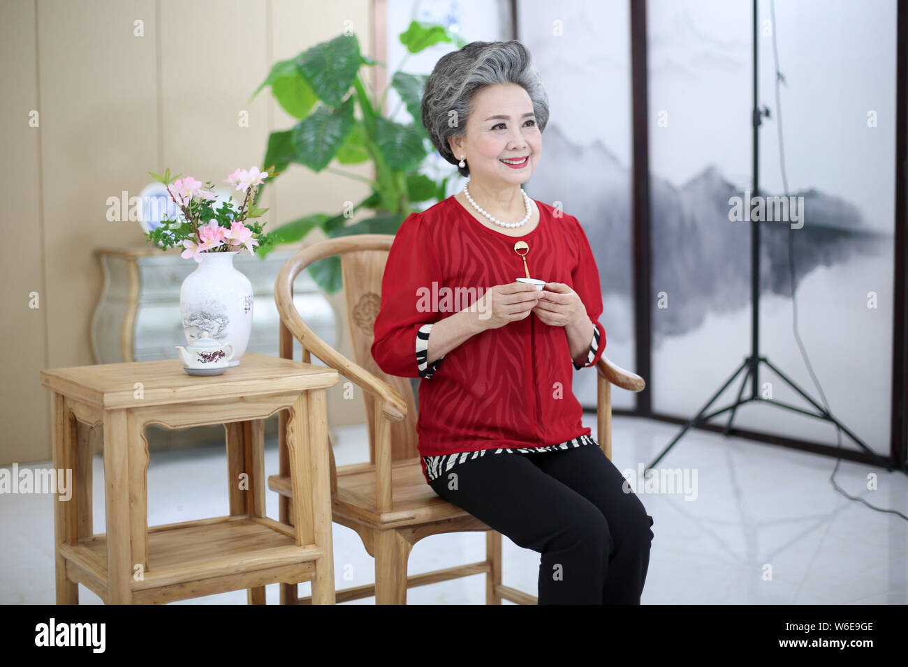 71-year-old Chinese woman Yang Guang poses for photos as she works as a ...