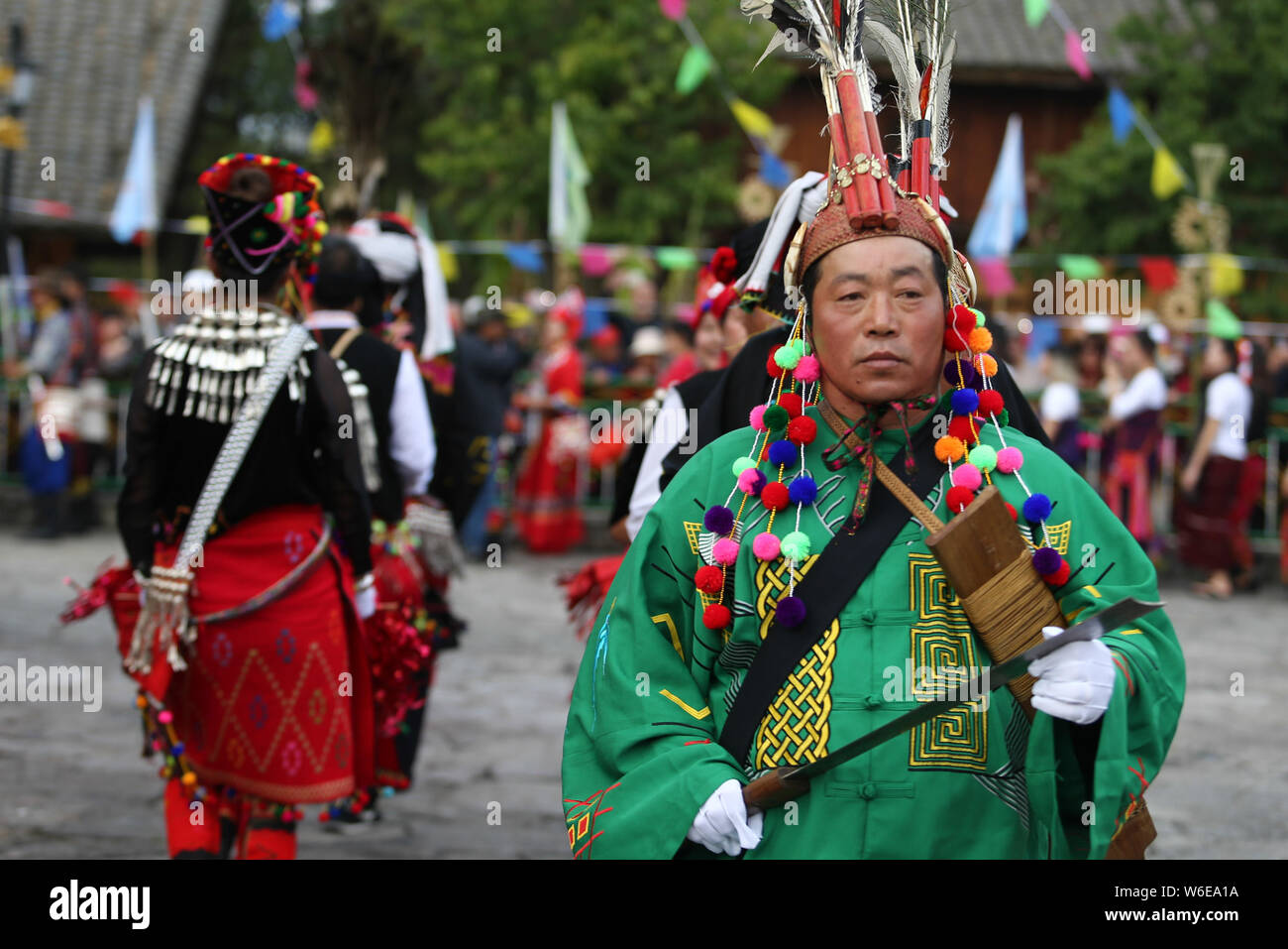 Chinese people of Jingpo ethnic group wearing traditional costumes and ...