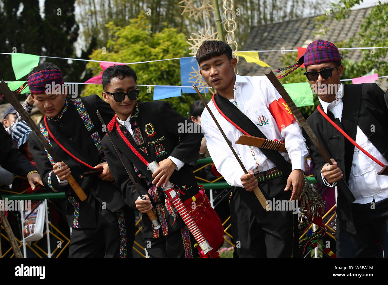 Chinese people of Jingpo ethnic group wearing traditional costumes and ...
