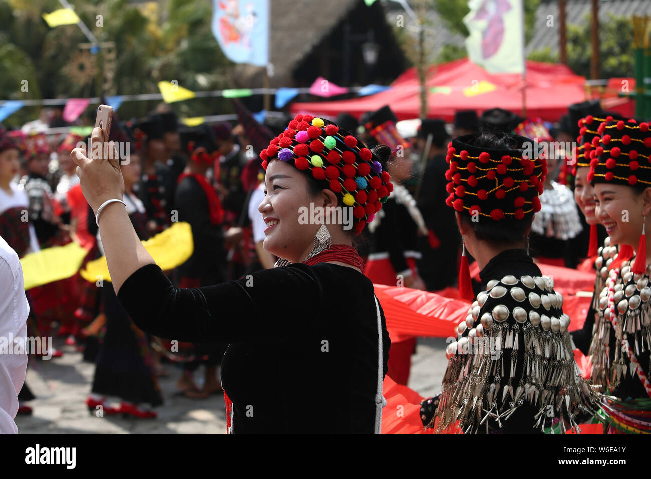 Chinese people of Jingpo ethnic group wearing traditional costumes and ...