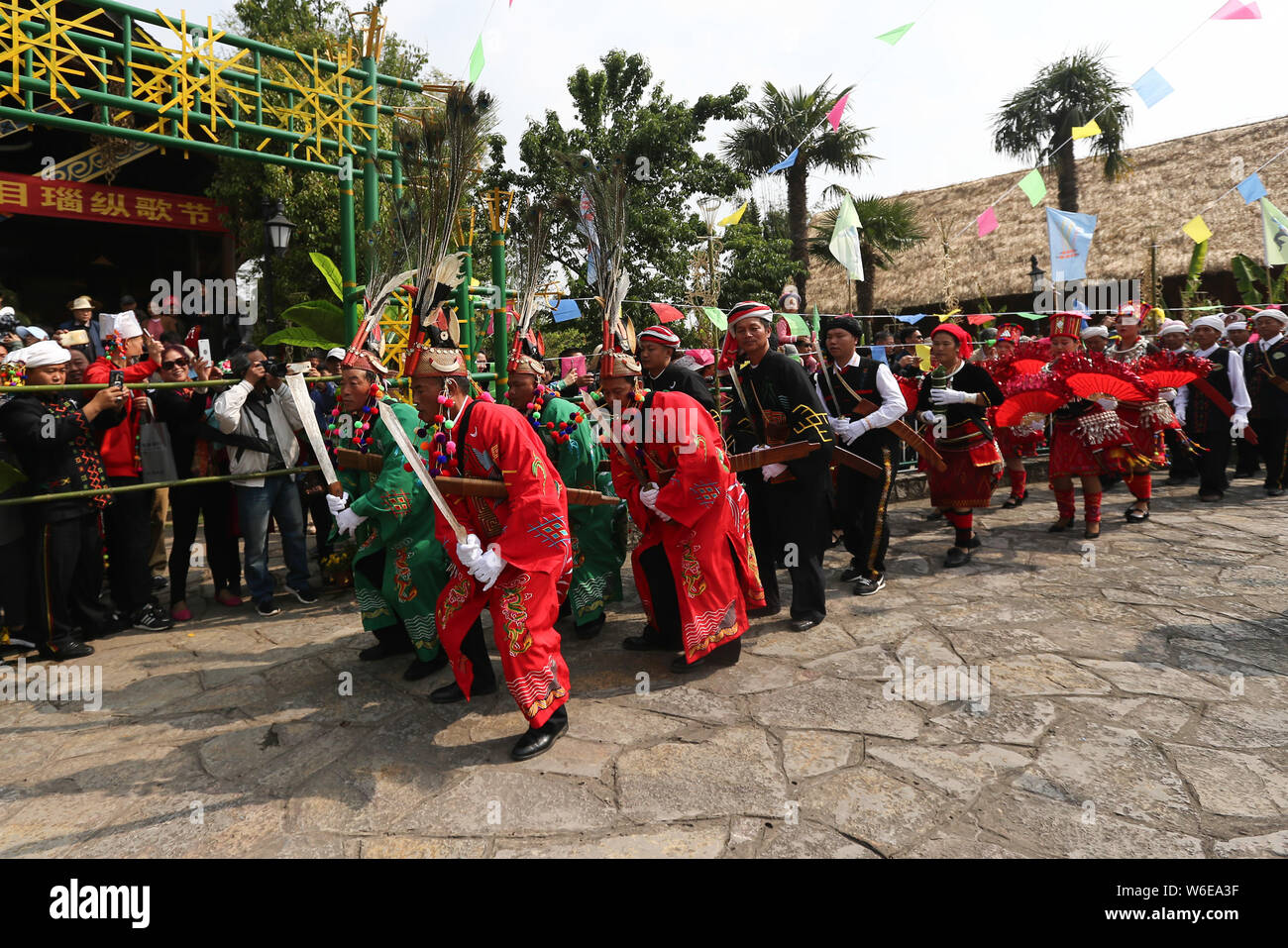 Chinese people of Jingpo ethnic group wearing traditional costumes and ...