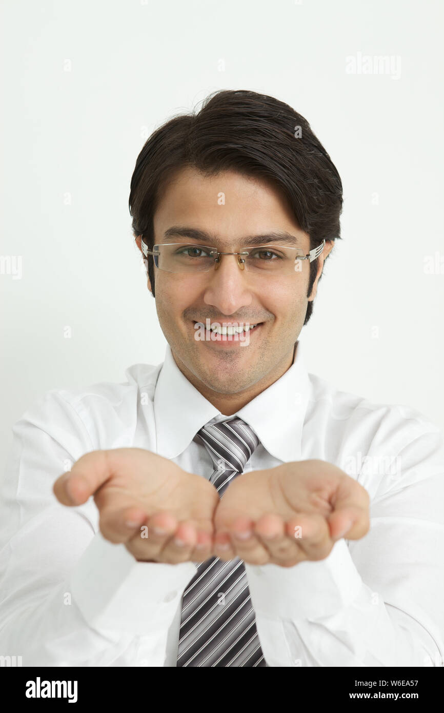 Portrait of a businessman cupping hands smiling Stock Photo - Alamy