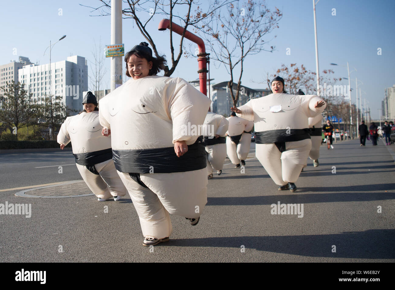 Chinese women dressed in inflatable sumo-wrestler costumes take part in ...
