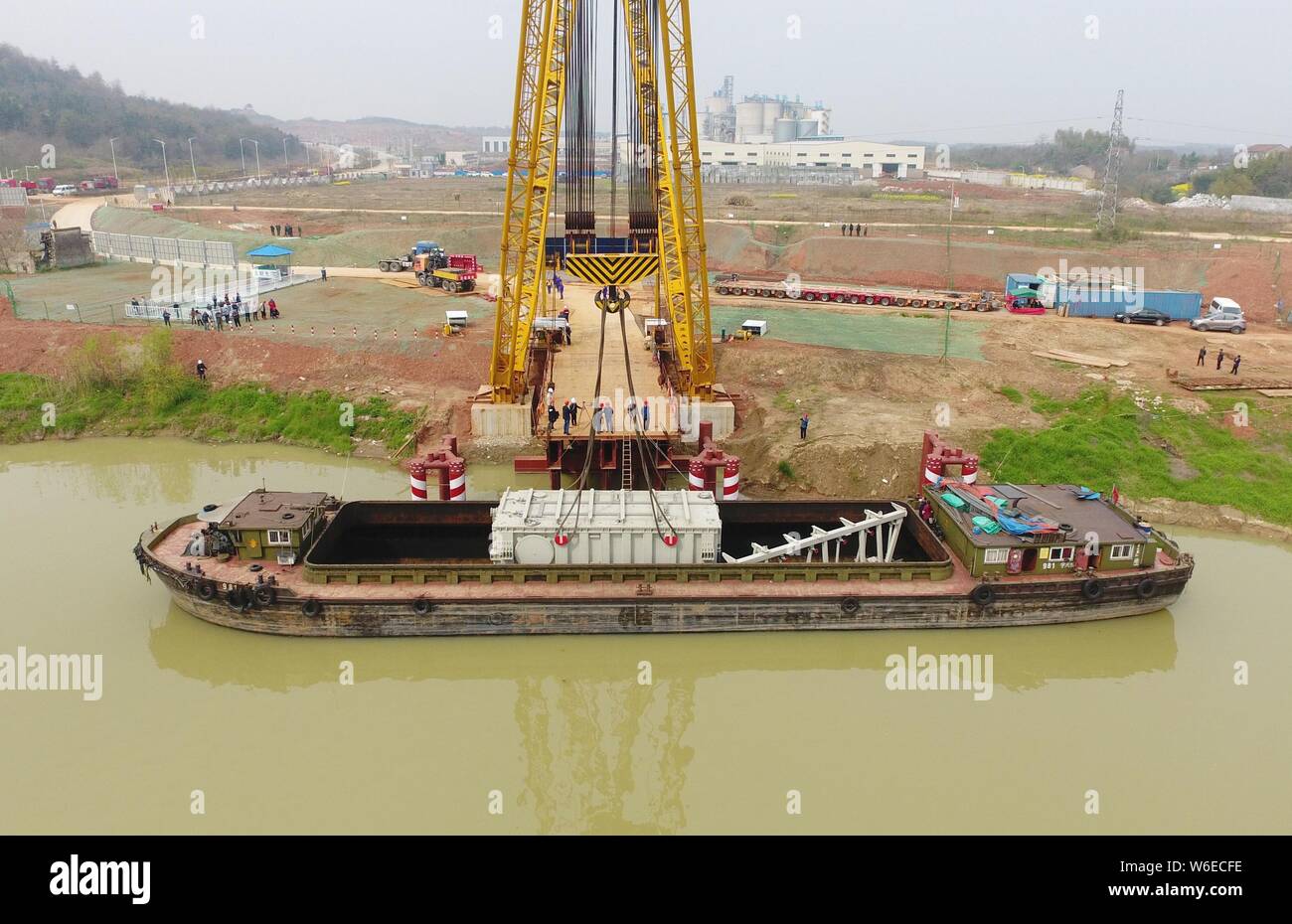 A crane vehicle lifts the world's most powerful converter transformer ...