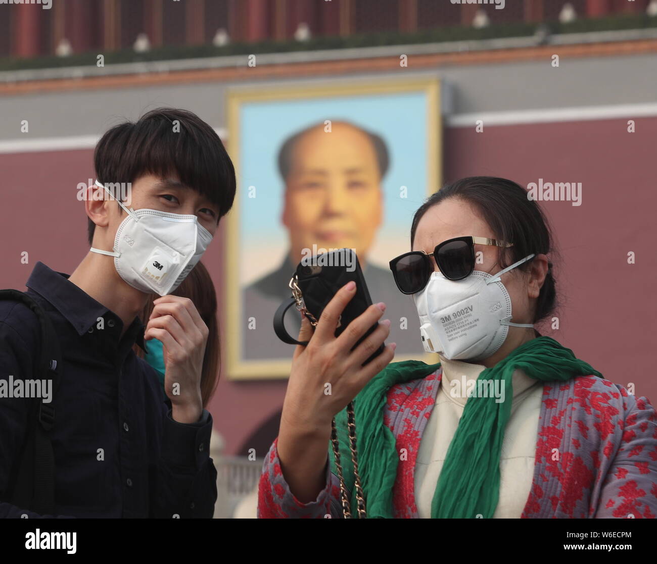 --FILE--Tourists wearing face masks against air pollution visit the ...