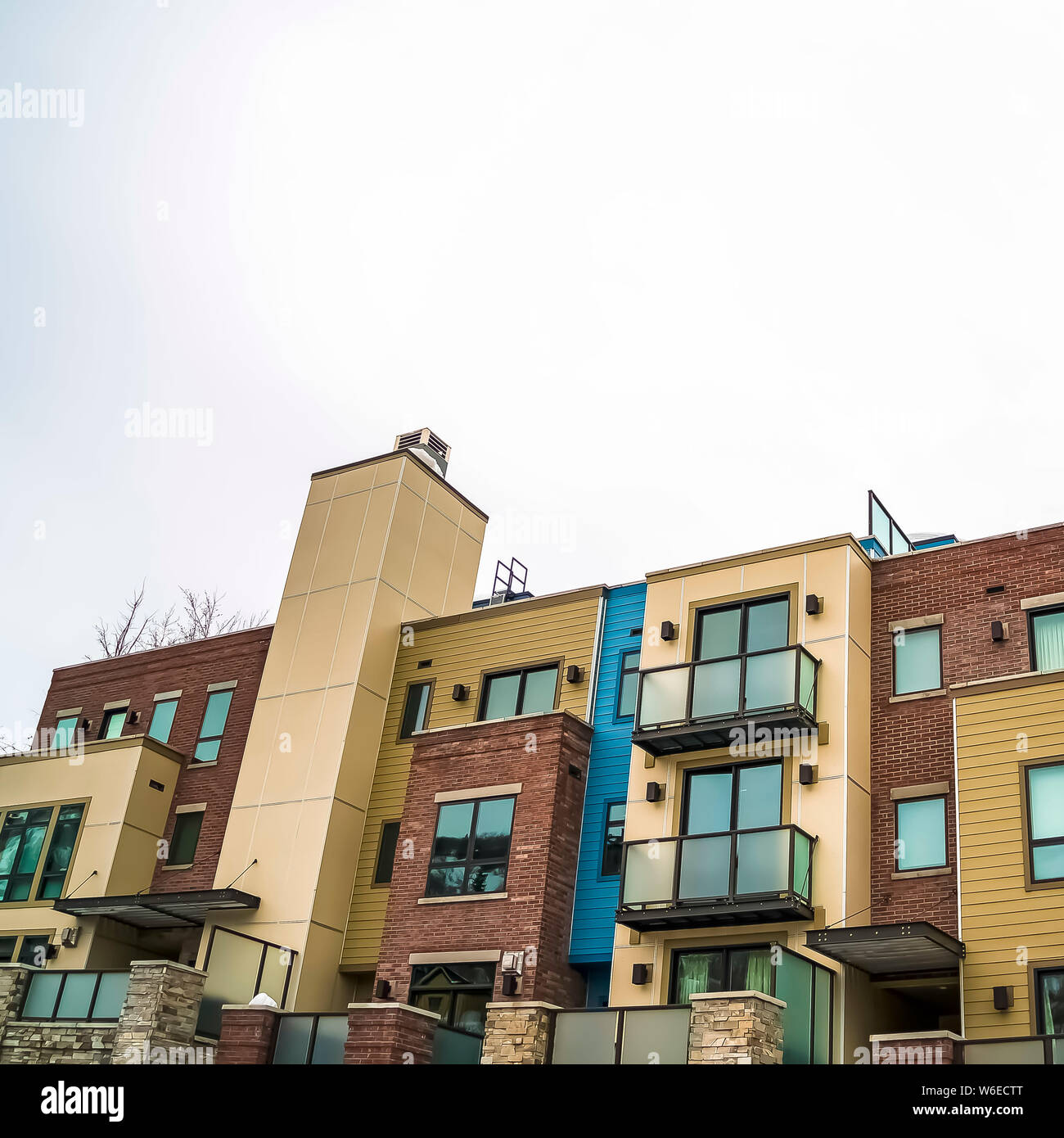 Square Residential building facade with flat roof and balconies with ...