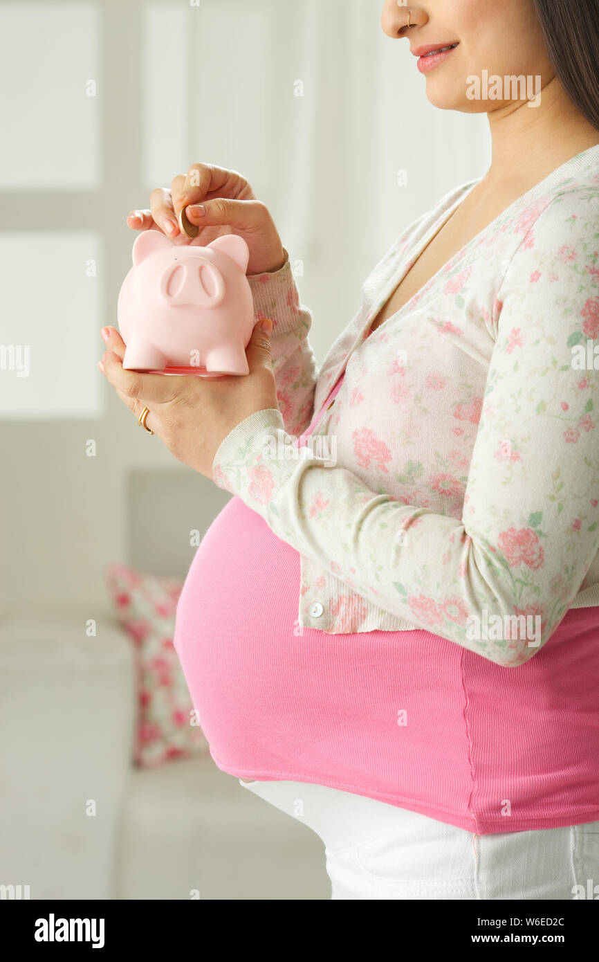 Pregnant woman holding coin bank hi-res stock photography and images ...