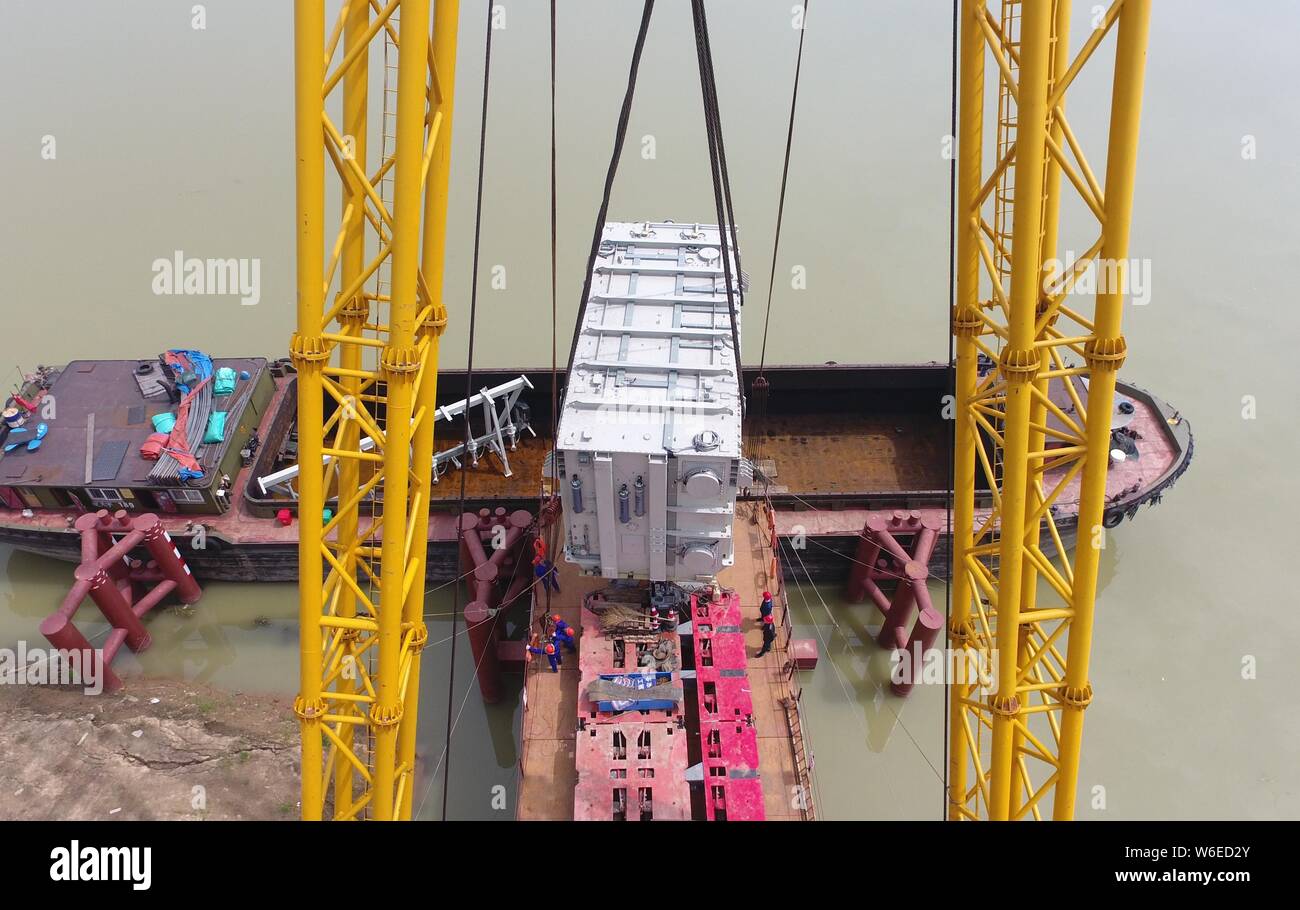 A crane vehicle lifts the world's most powerful converter transformer ...
