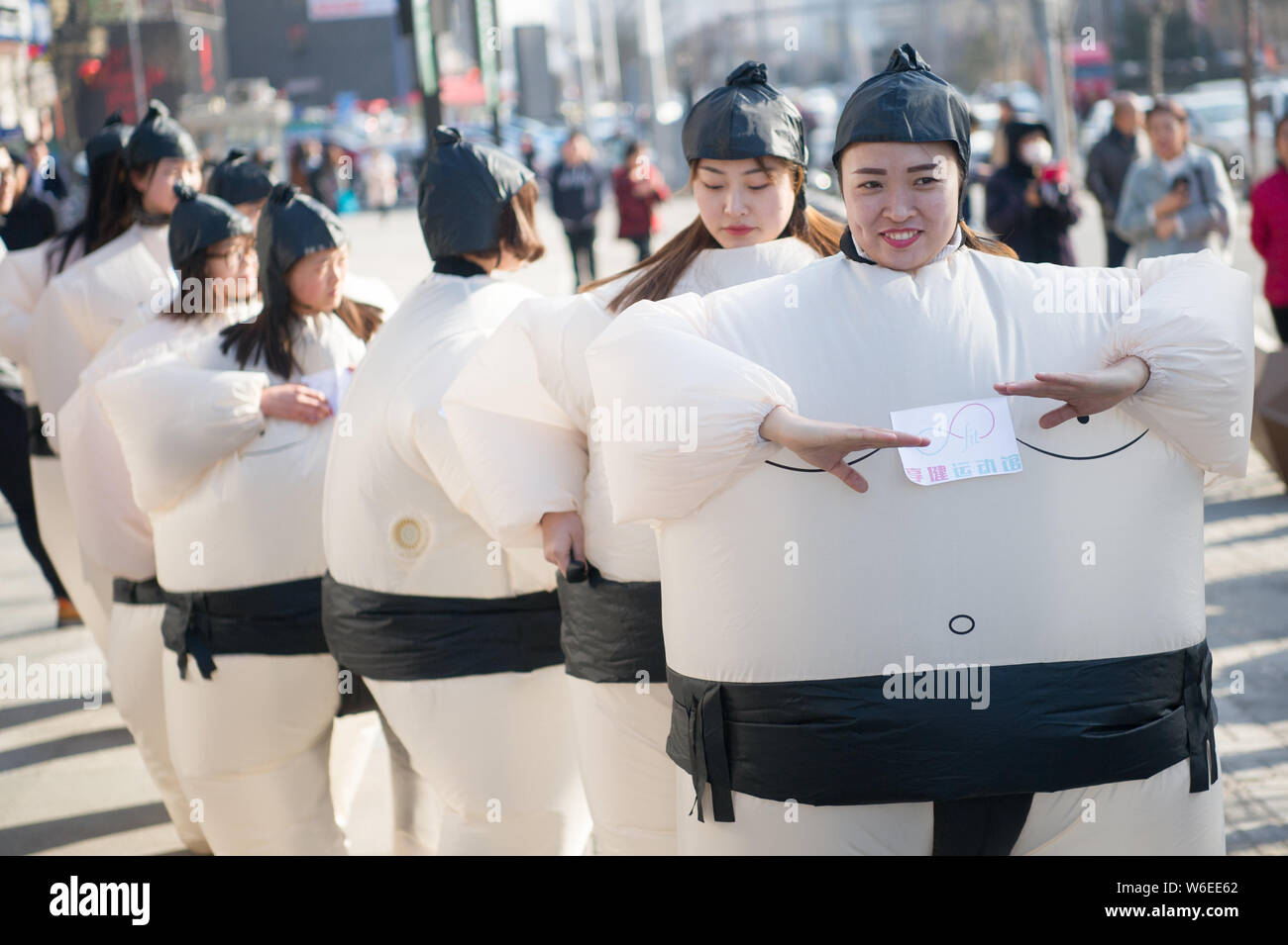 Chinese women dressed in inflatable sumo-wrestler costumes take part in ...