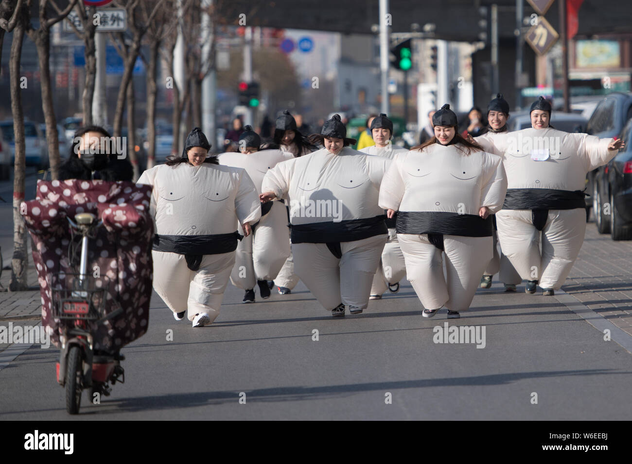 Chinese women dressed in inflatable sumo-wrestler costumes take part in ...
