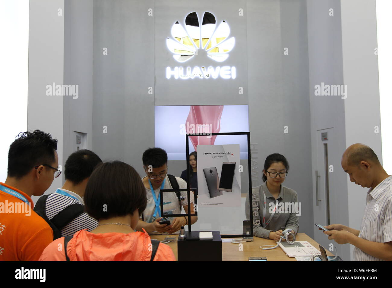 --FILE--People visit the stand of Huawei during an exhibition in ...
