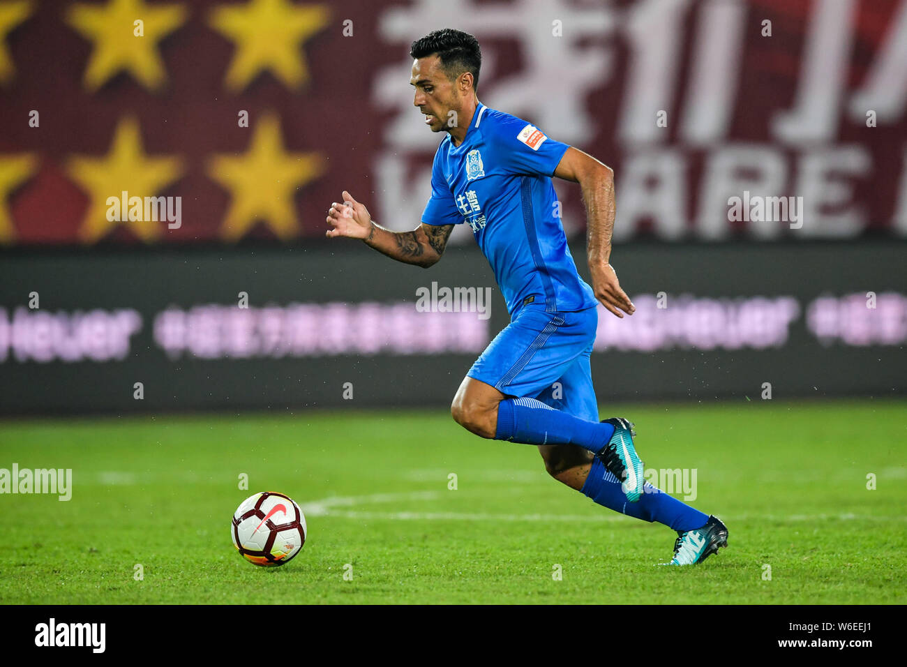 Israeli football player Eran Zahavi, right, of Guangzhou R&F dribbles ...