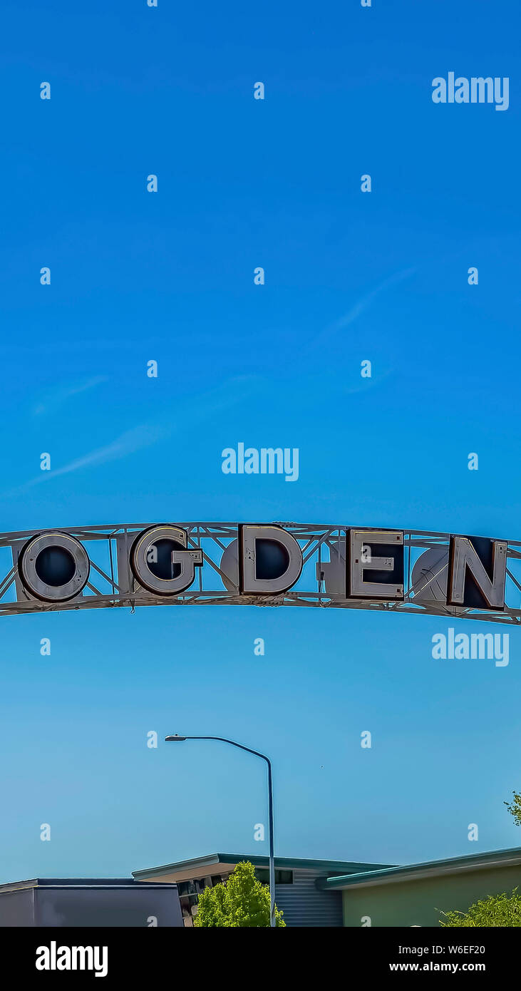 Vertical frame Welcome arch at the city of Ogden in Utah against lush ...