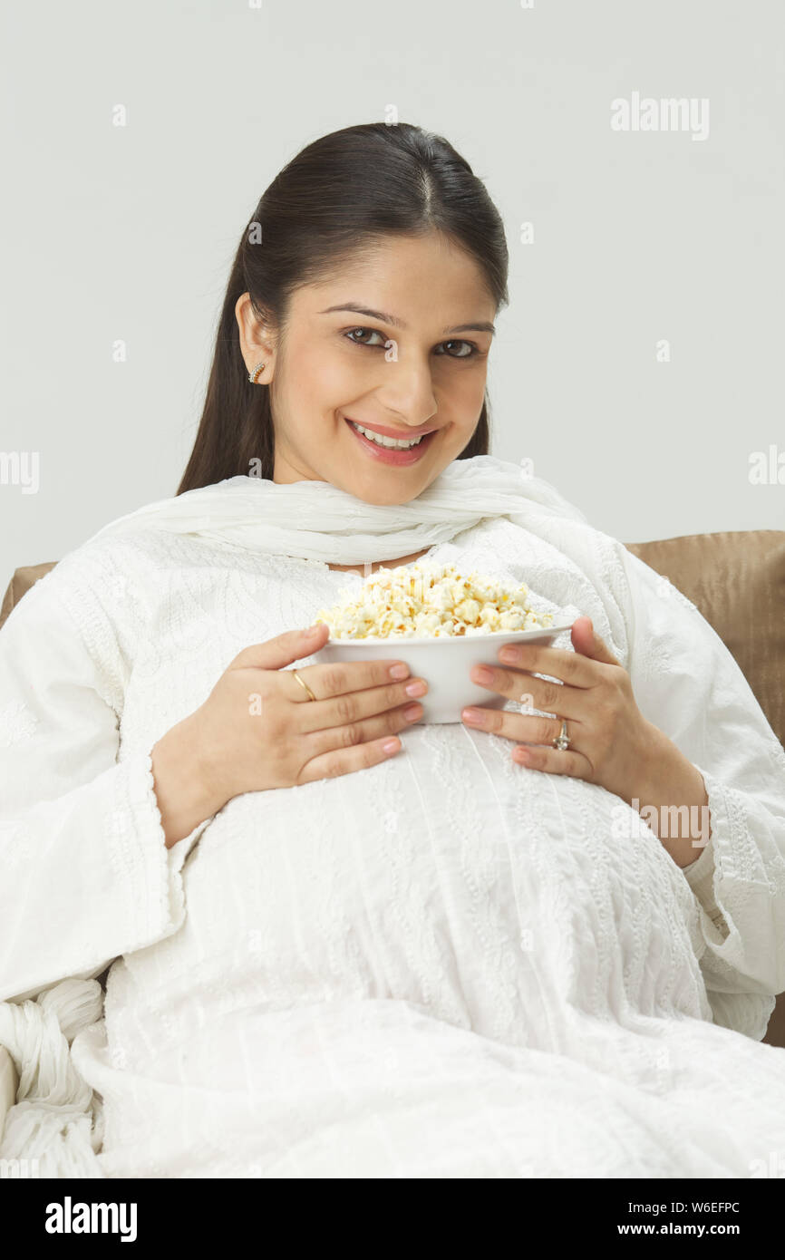 Pregnant woman eating popcorn hi-res stock photography and images - Alamy